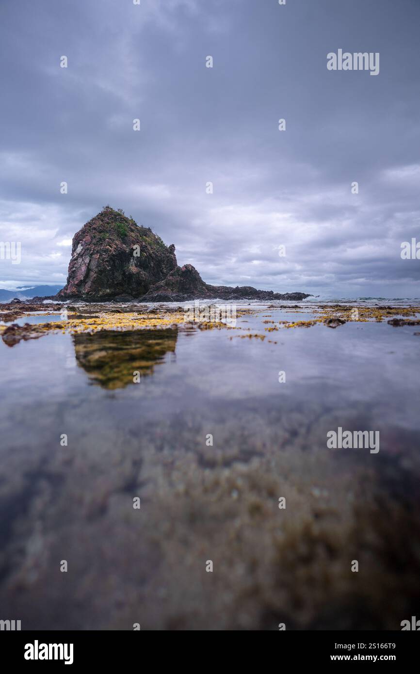 A dramatic coastal scene of Diguisit, Aurora featuring two rugged rock ...