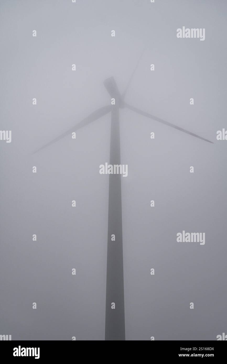 Barely visible wind turbine hidden in the fog on a winter day Stock ...