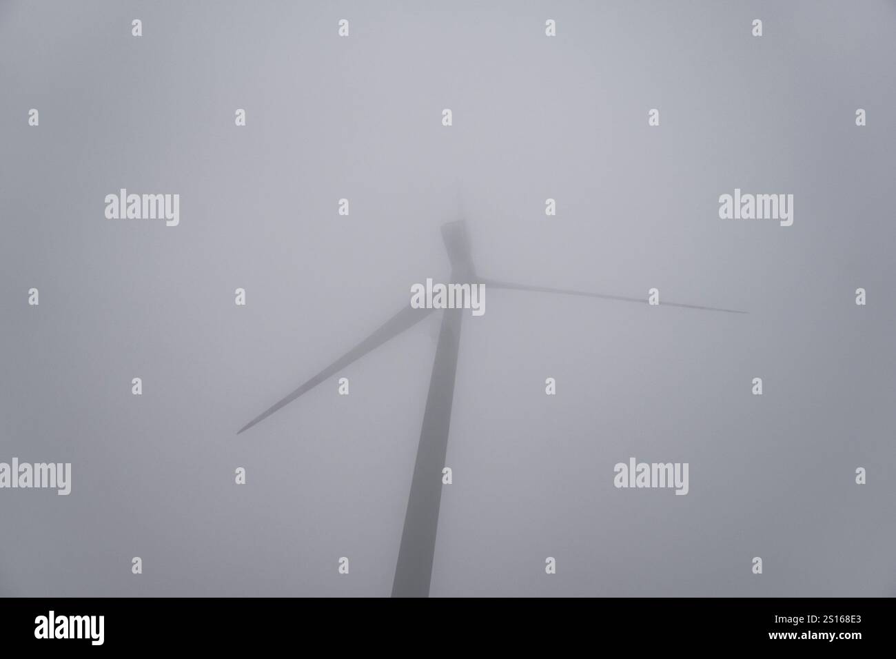 Barely visible wind turbine hidden in the fog on a winter day Stock ...