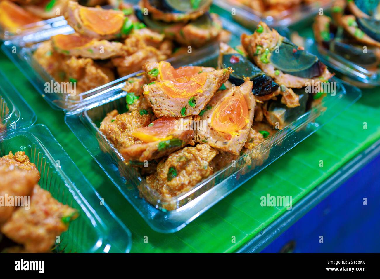 Fried Salted Egg Wrapped With Curried Fish Cake Stock Photo - Alamy