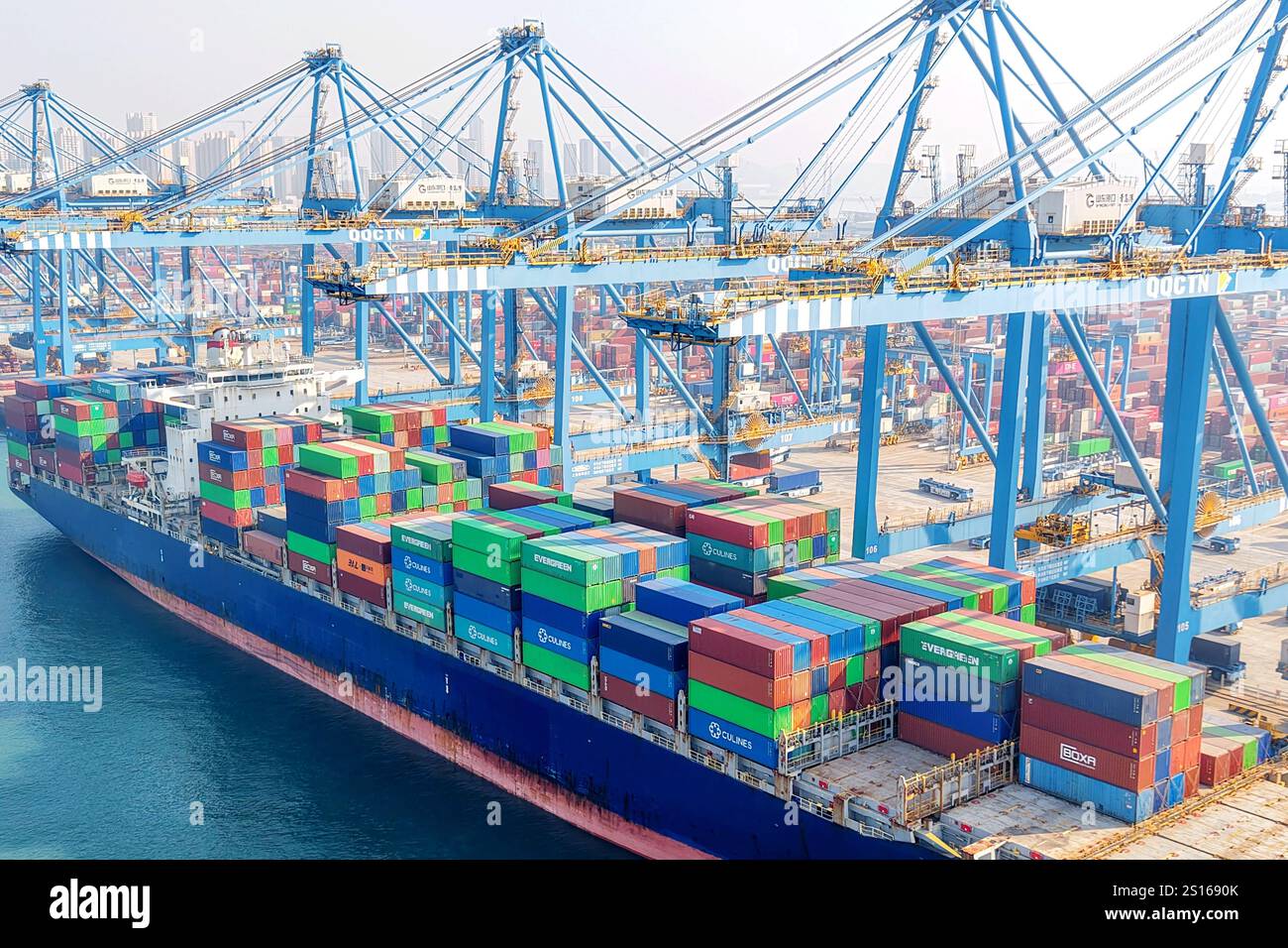 QINGDAO, CHINA - JANUARY 1, 2025 - Cargo ships load and unload ...