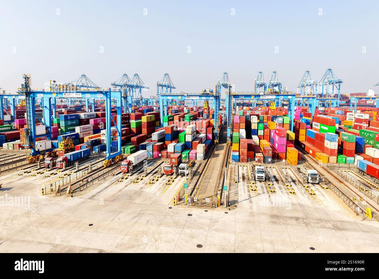 QINGDAO, CHINA - JANUARY 1, 2025 - Trucks load foreign trade containers at the fully automated ...