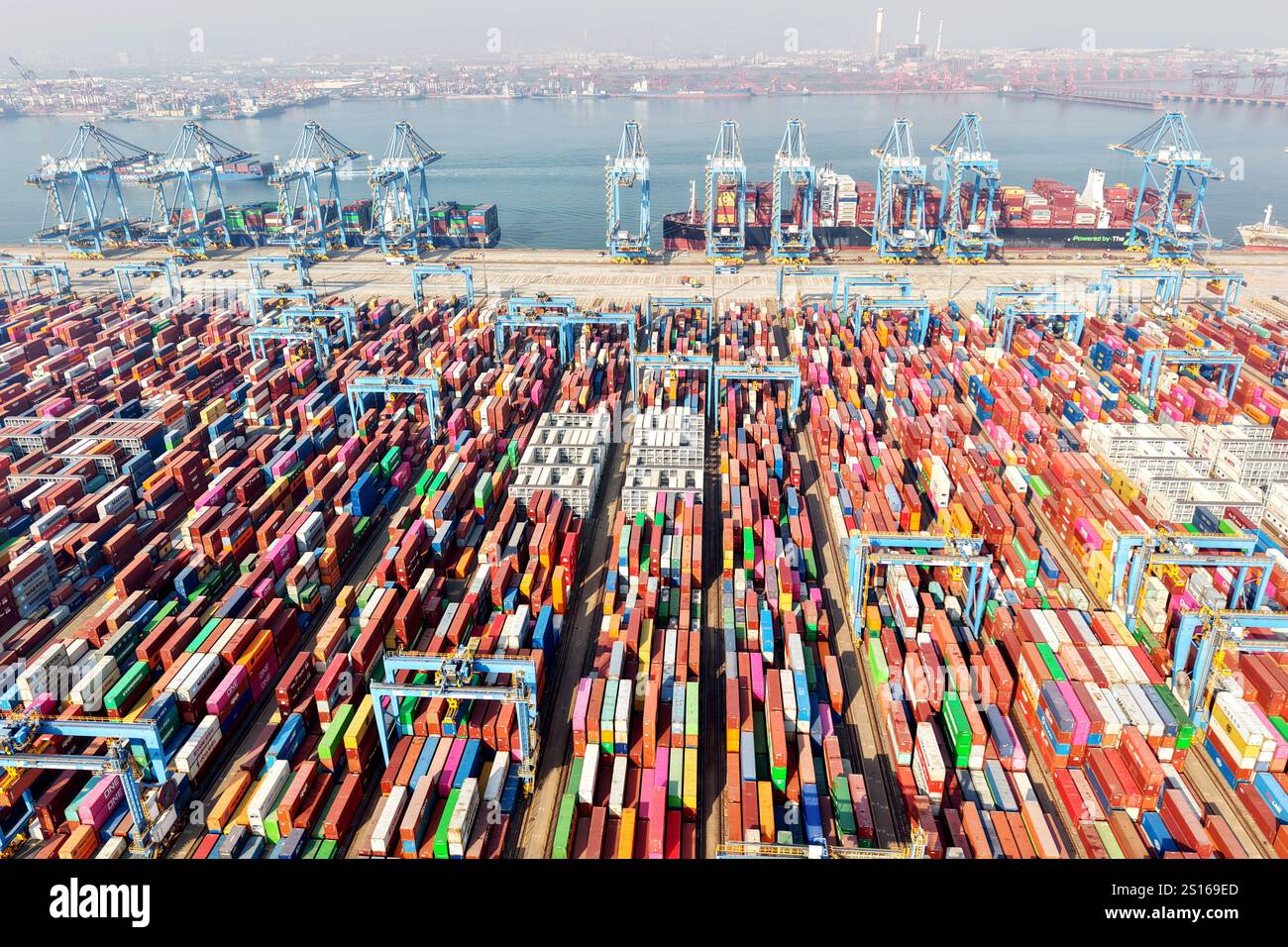 QINGDAO, CHINA - JANUARY 1, 2025 - Cargo ships load and unload ...