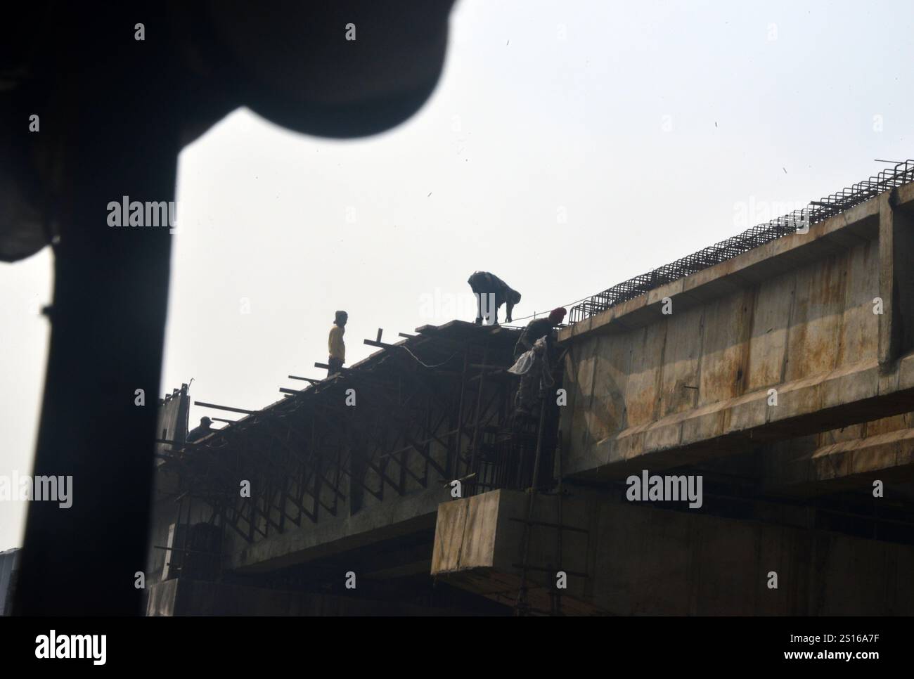 Siliguri, West Bengal, India. 1st Jan, 2025. Workers work at four lane ...