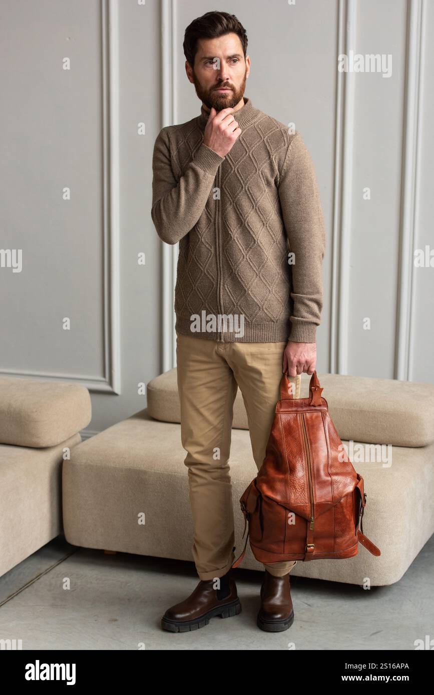 A Stylish and Professional Man Standing with brown yellow backpack in a ...