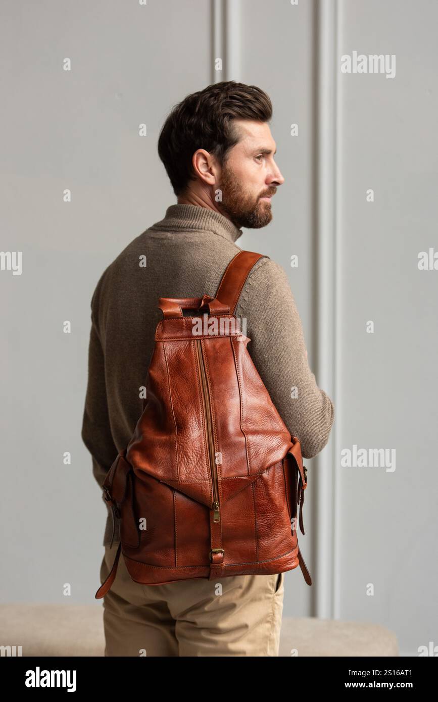 A Stylish and Professional Man Standing with brown yellow backpack in a ...