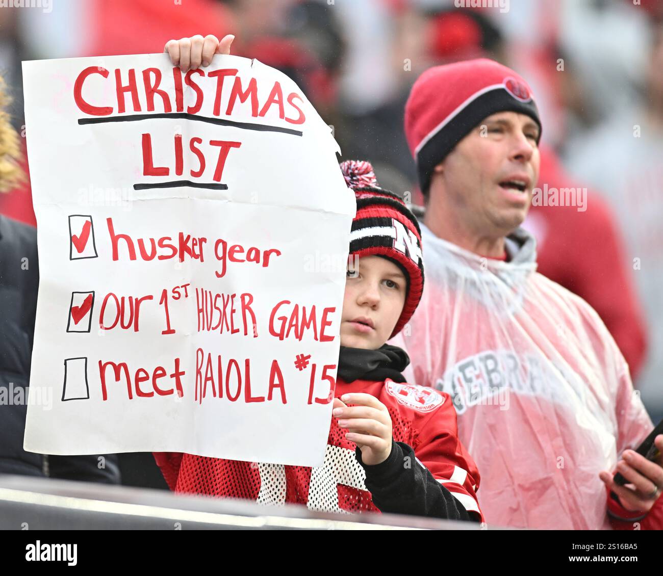BRONX, NY - DECEMBER 28: Nebraska Cornhuskers fan holds up a sign ...