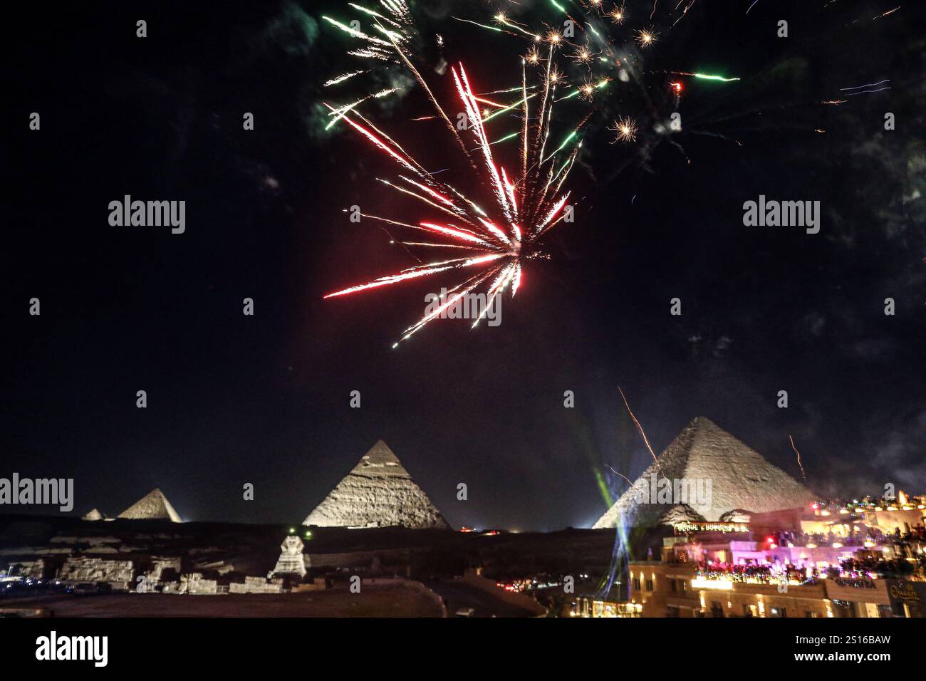 Giza, Egypt. 31st Dec, 2024. Fireworks explode over the Giza Pyramids ...