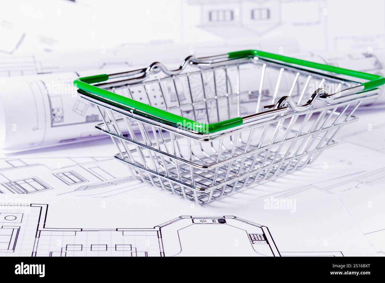 Construction plan in grocery basket. House design project. Miniature ...