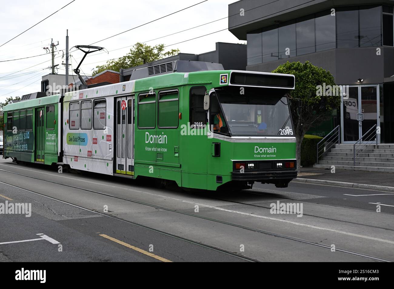 B-Class articulated tram, operated by Yarra Trams, covered in green ...