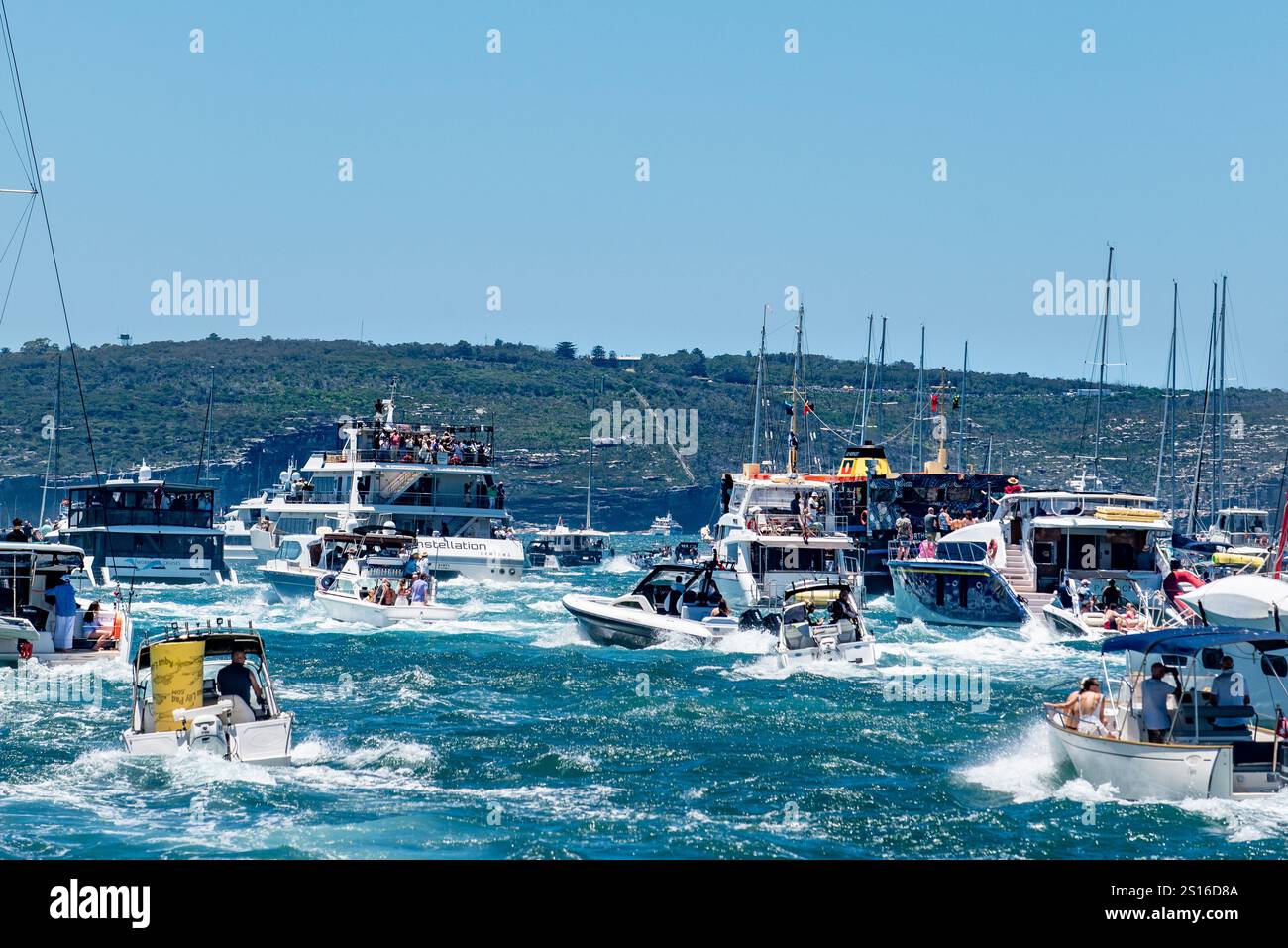 A large flotilla of spectator craft follow the leaders towards the open ...