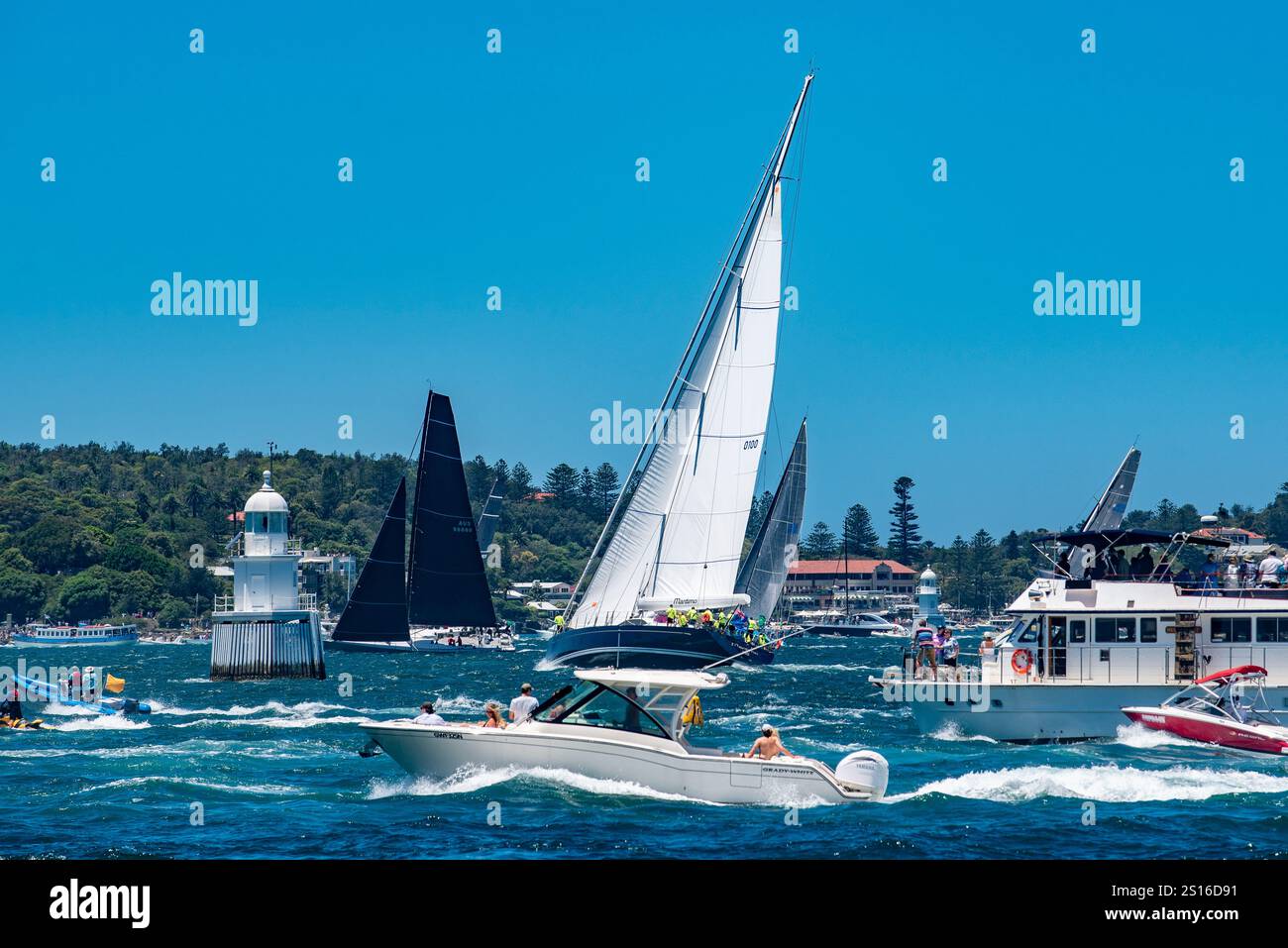 A large flotilla of spectator craft follow the leaders towards the open ...