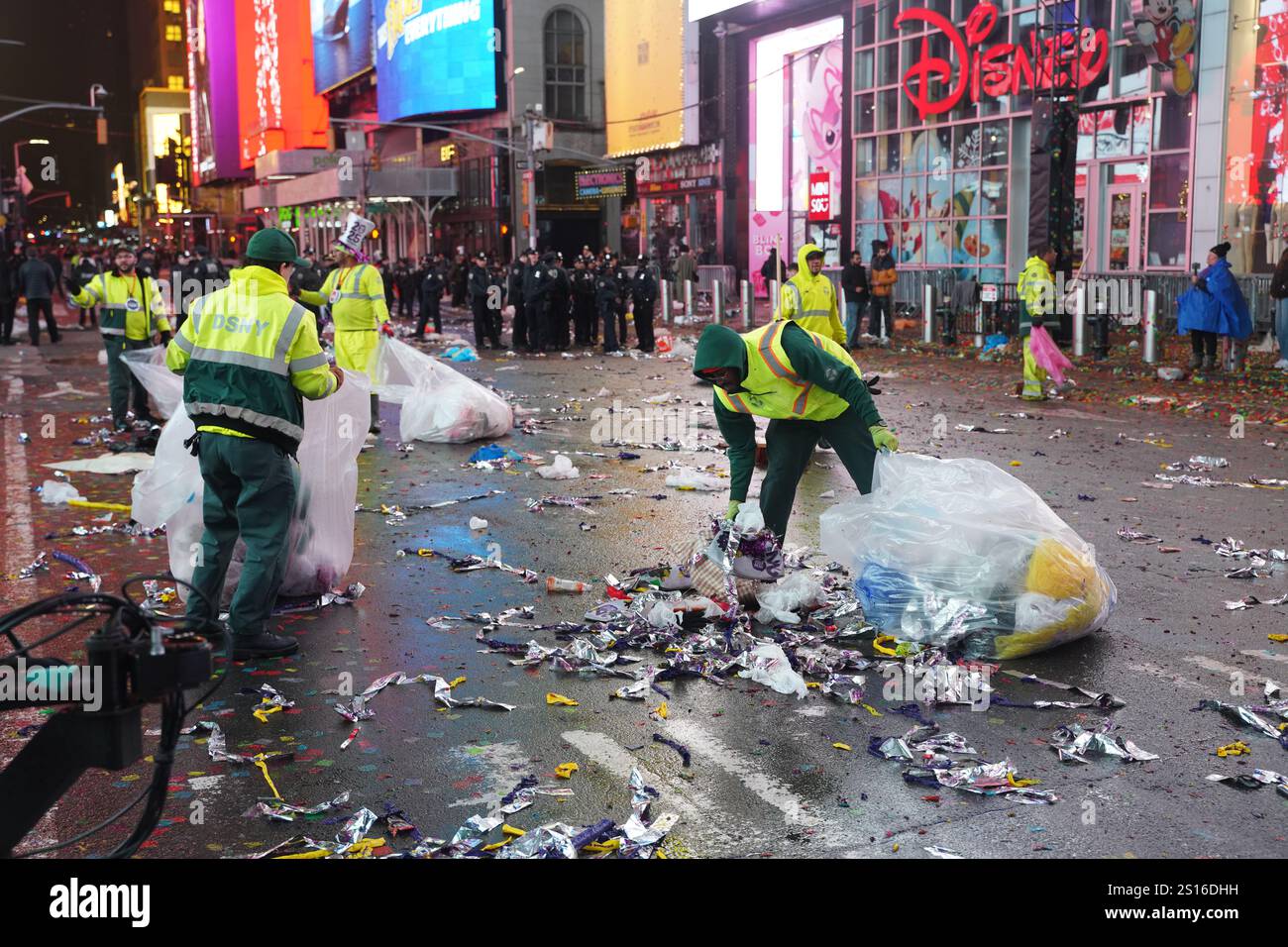 Workers of the City of New York's Department of Sanitation (DSNY) clean ...