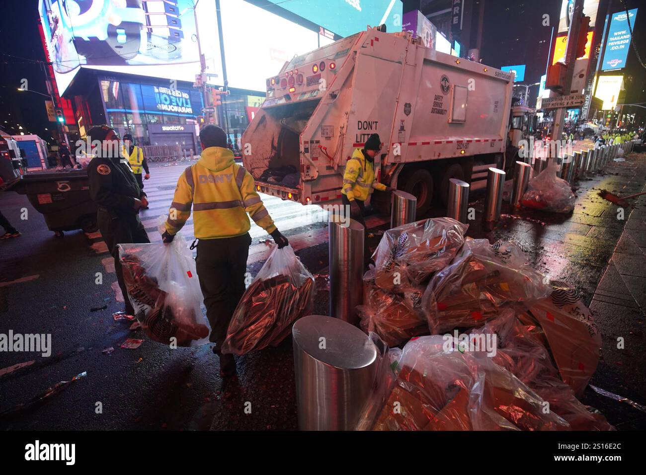 Workers of the City of New York's Department of Sanitation (DSNY) clean ...