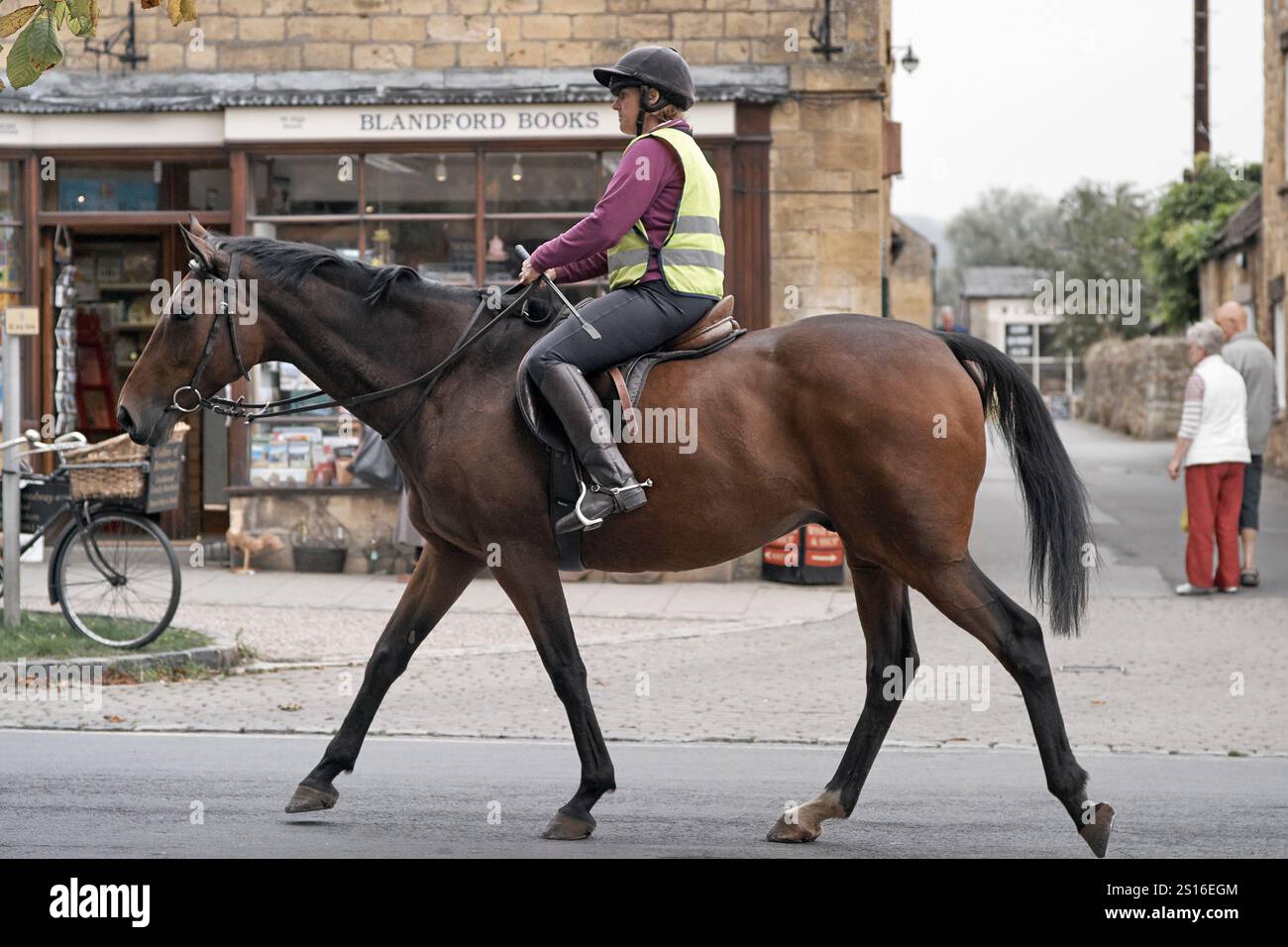 Horse and rider in the High Street Broadway, Cotswolds, England, UK ...
