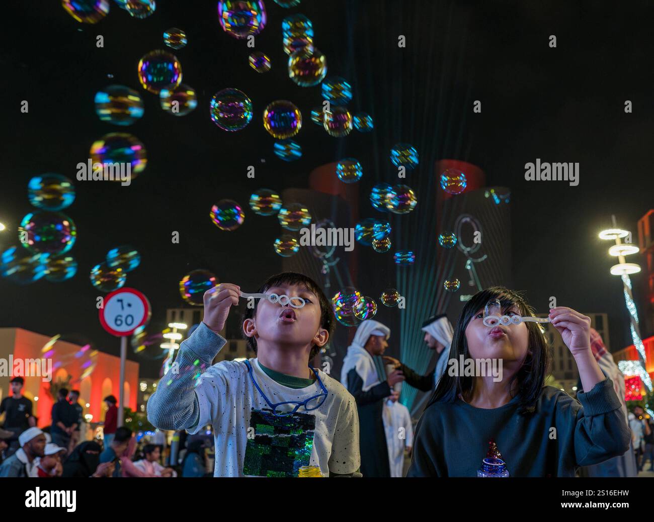 NEW YEAR CELEBRATIONS IN DOHA Children blow bubbles at Lusail Boulevard during 2025 New YearÕs ...
