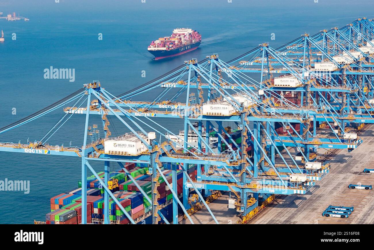 QINGDAO, CHINA - JANUARY 1, 2025 - Cargo ships load and unload ...
