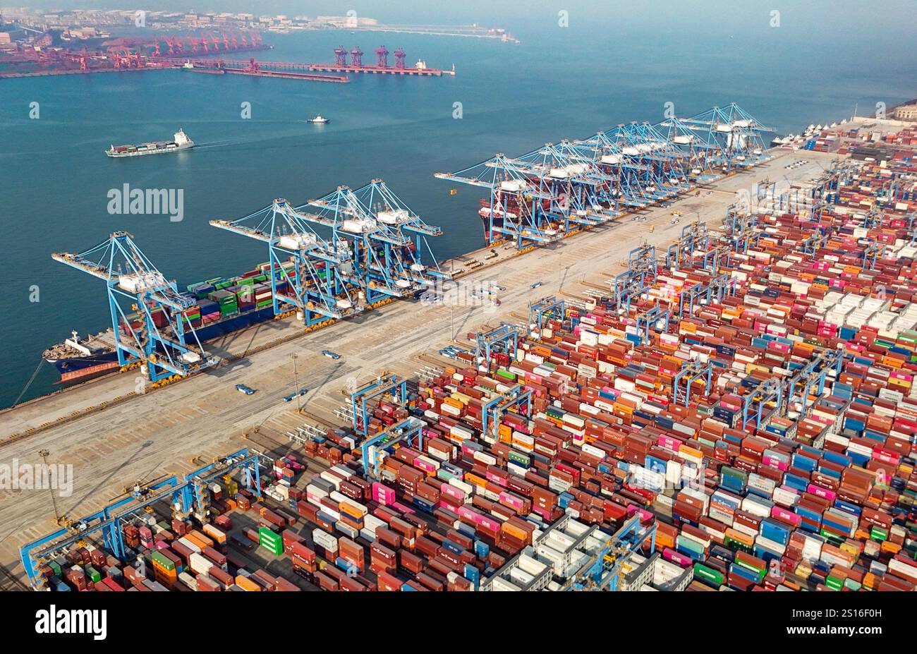 QINGDAO, CHINA - JANUARY 1, 2025 - Cargo ships load and unload ...