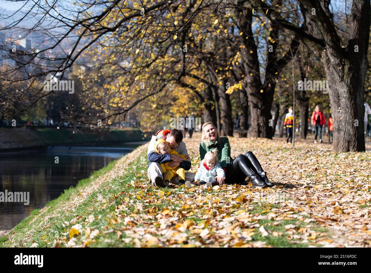 Autumn Park Scene With Parents And Little Twins Smiling Together Stock ...