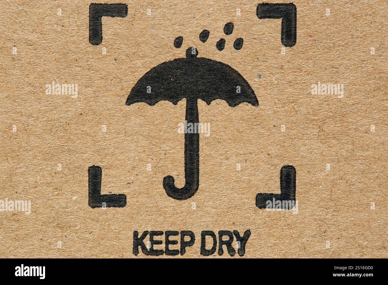 Keep dry warning printed on a cardboard box background. Cargo freight ...