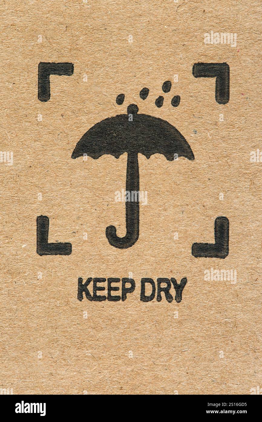 Keep dry warning printed on a cardboard box background. Cargo freight ...
