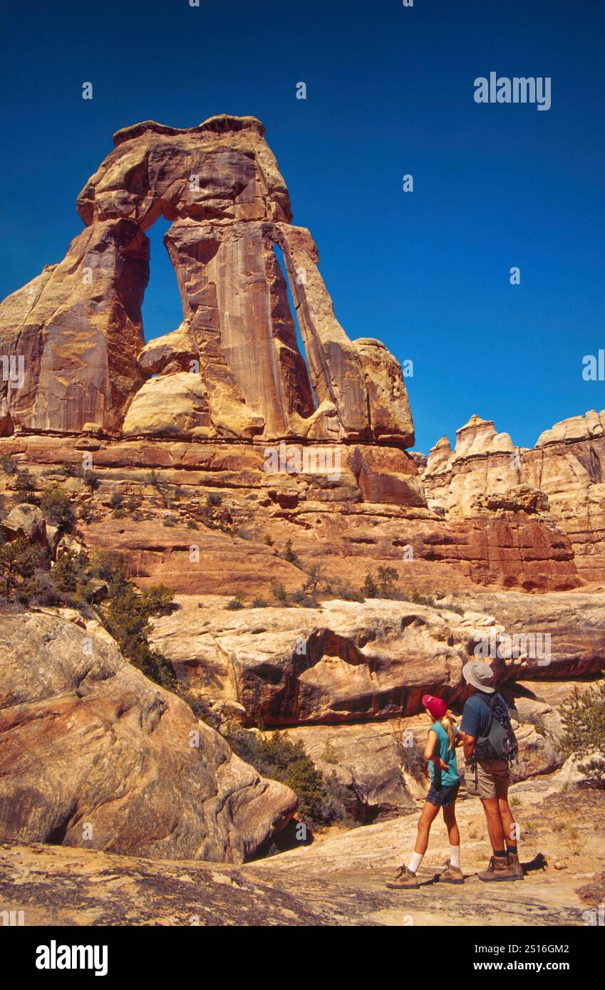 Hikers, man and his daughter, at Druid Arch at Needles District in ...