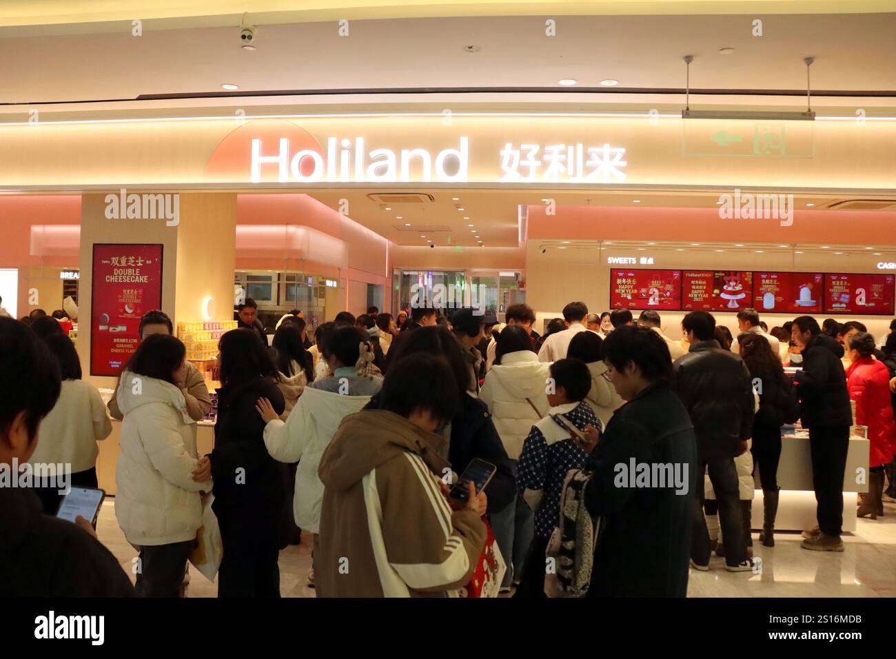 YICHANG, CHINA - DECEMBER 31, 2024 - People shop at Holiland Bakery in ...