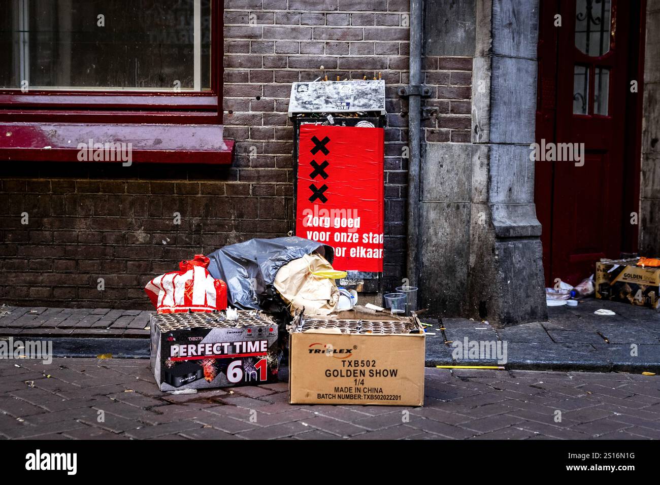 AMSTERDAM - Remnants of fired fireworks on the street in Warmoesstraat ...