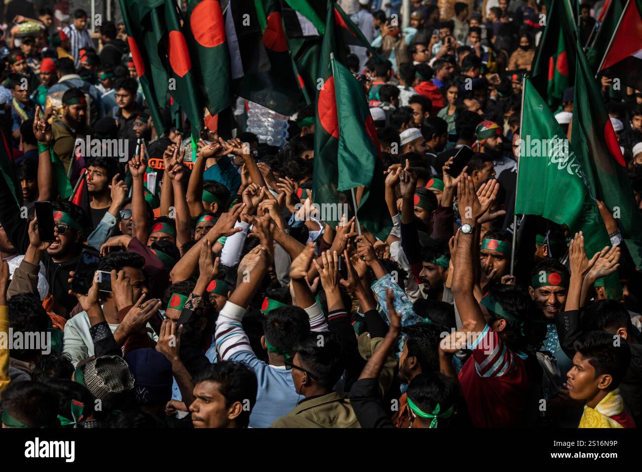 Dhaka, Bangladesh. 31st Dec, 2024. Students and supporters shout slogans and hold Bangladesh ...