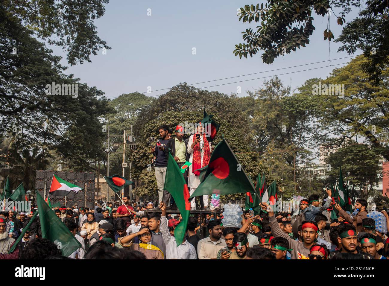 Dhaka, Bangladesh. 31st Dec, 2024. Students and supporters shout slogans and hold Bangladesh ...