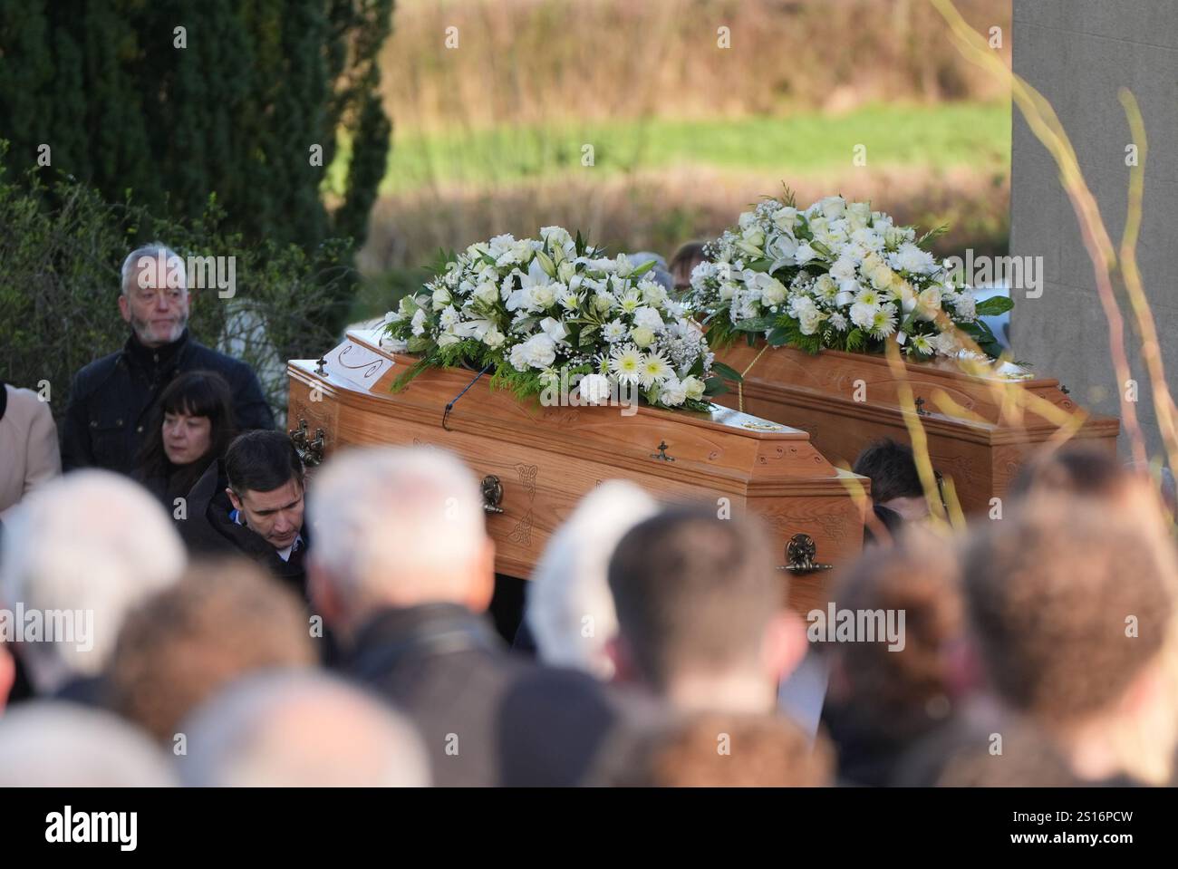 The coffins of father and son Peter and Loughlin Devlin, who were ...