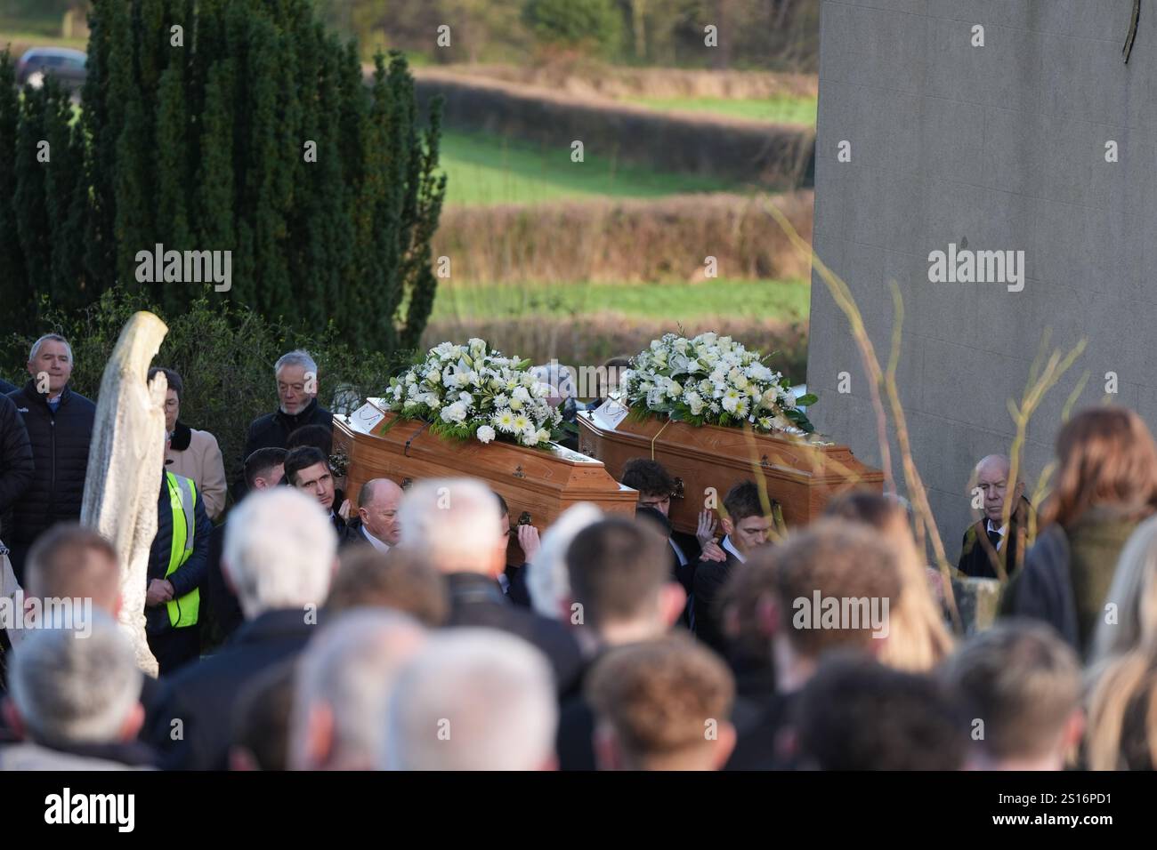 The coffins of father and son Peter and Loughlin Devlin, who were ...