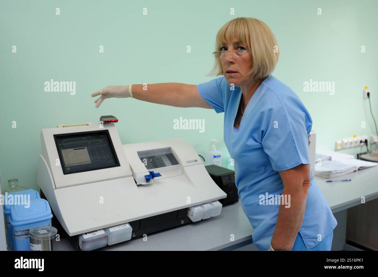 Lab technician performing analysis of blood samples with gas ...