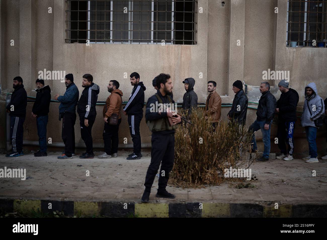 Members of ousted Syrian President Bashar Assad's army, line up to ...