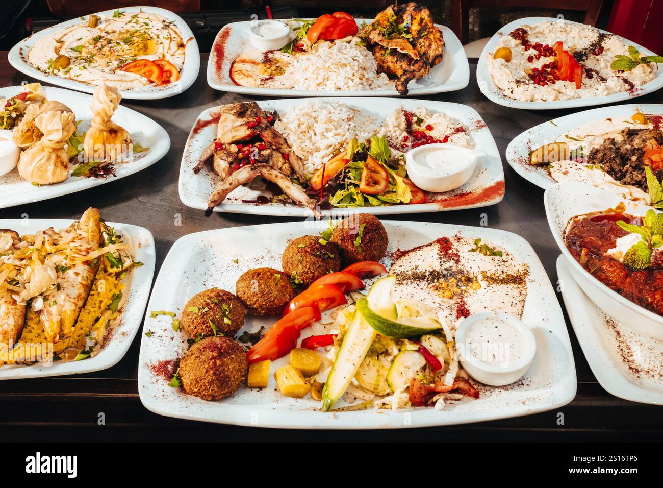 An abundant Mediterranean feast featuring grilled quail, falafel ...