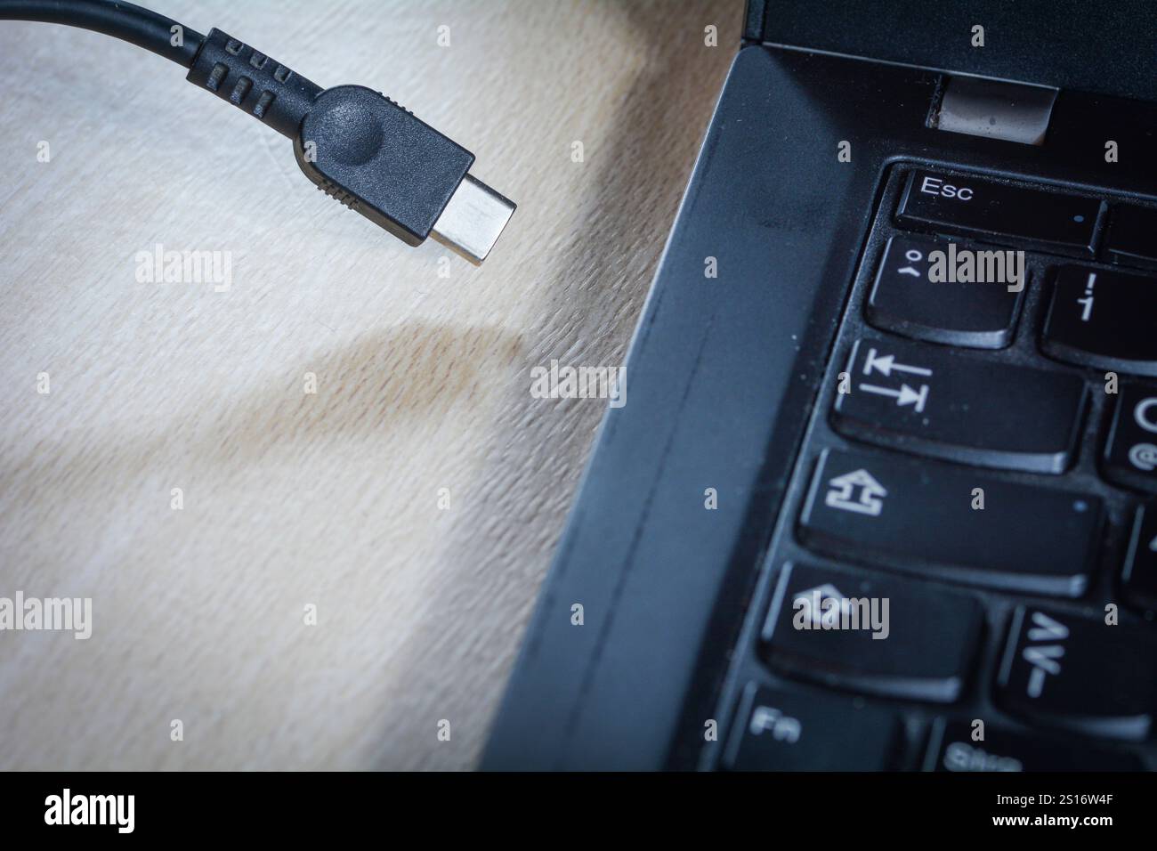 Concept photo of a USB-C cable with laptop keyboard Stock Photo - Alamy