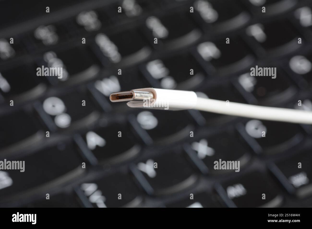 Concept photo of a USB-C cable with laptop keyboard Stock Photo - Alamy