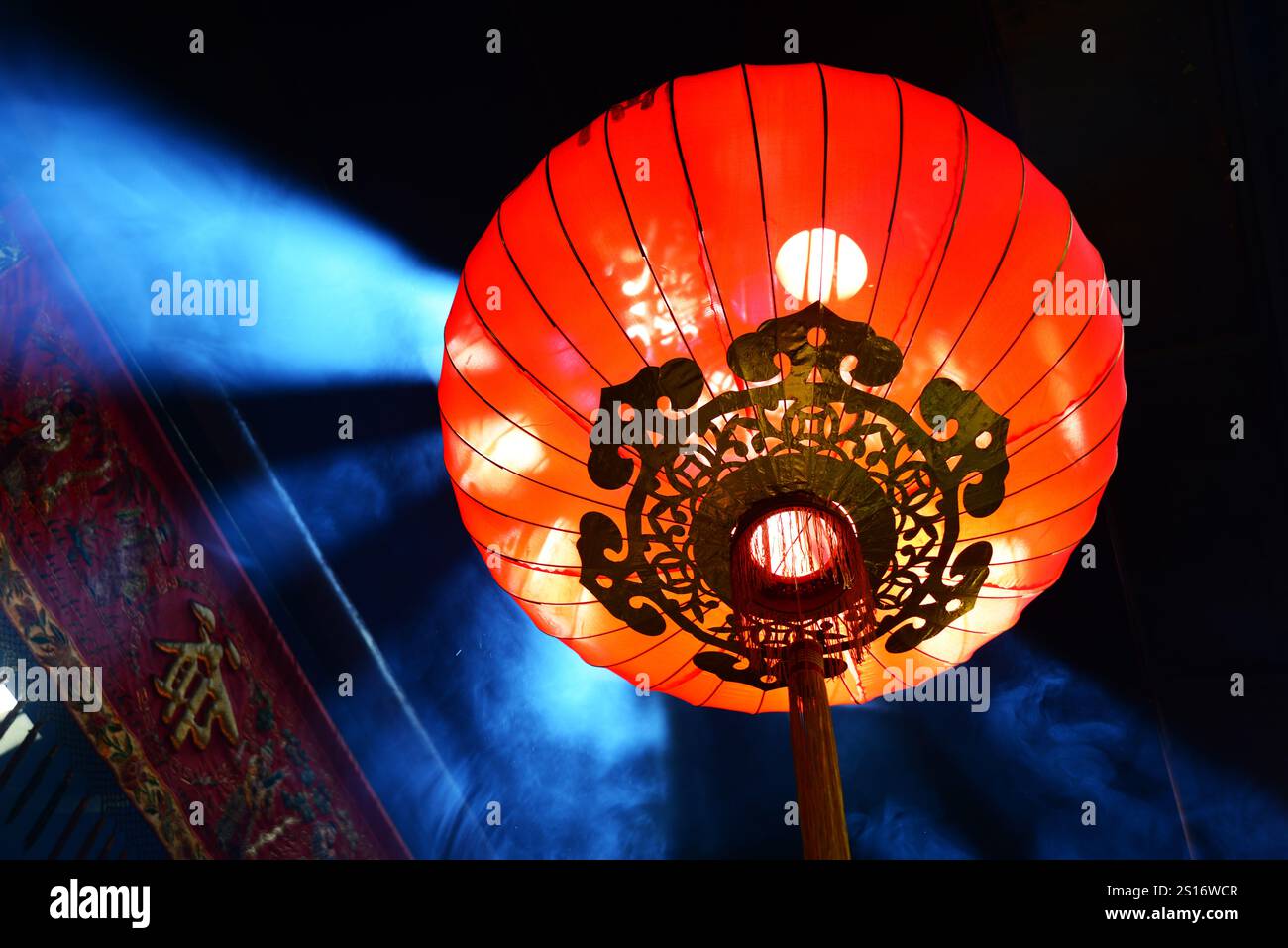 Glowing red lantern inside Sin Sze Si Ya traditional Chinese temple in ...