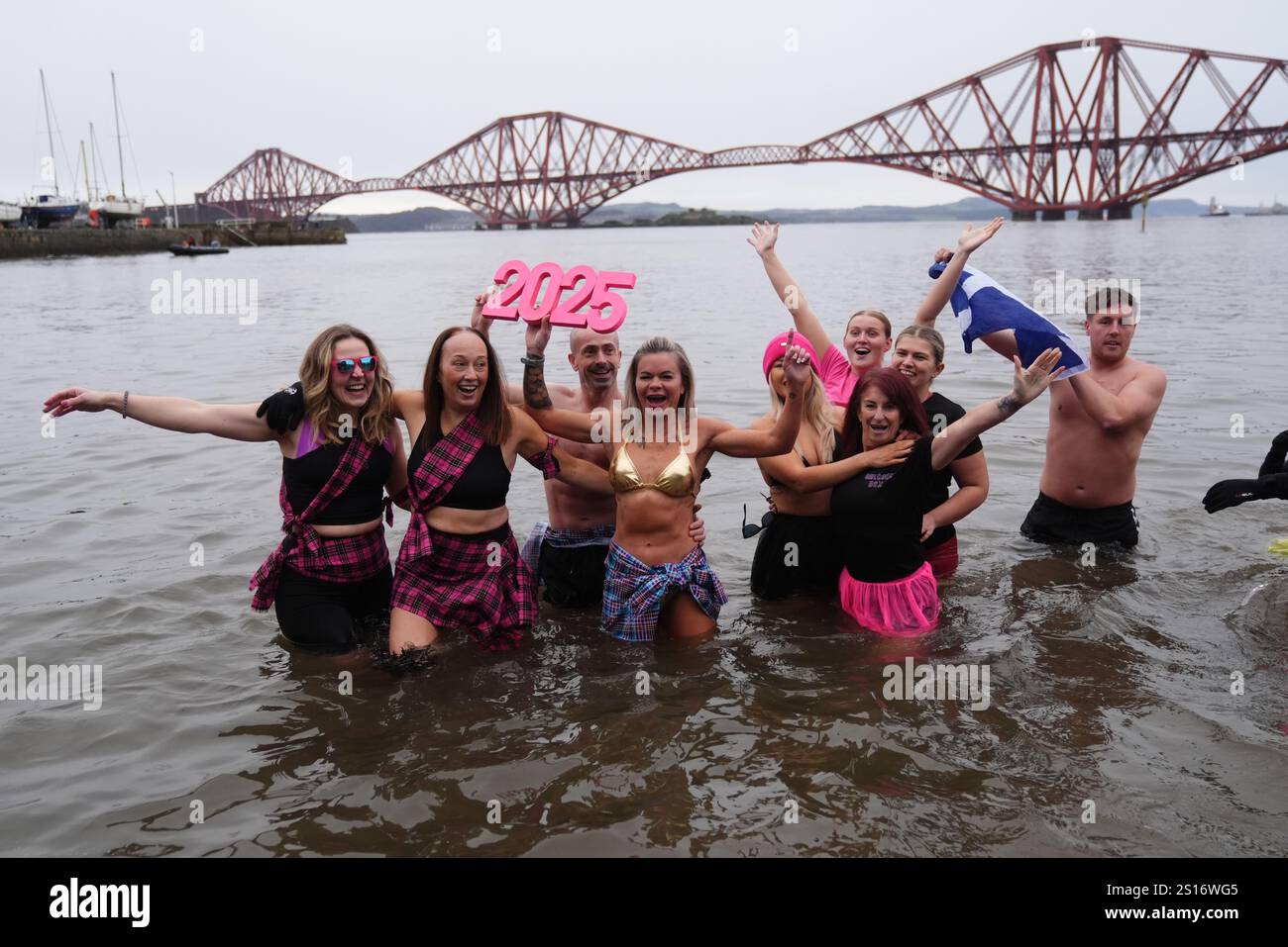 People take part in the Loony Dook New Year's Day dip in the Firth of ...
