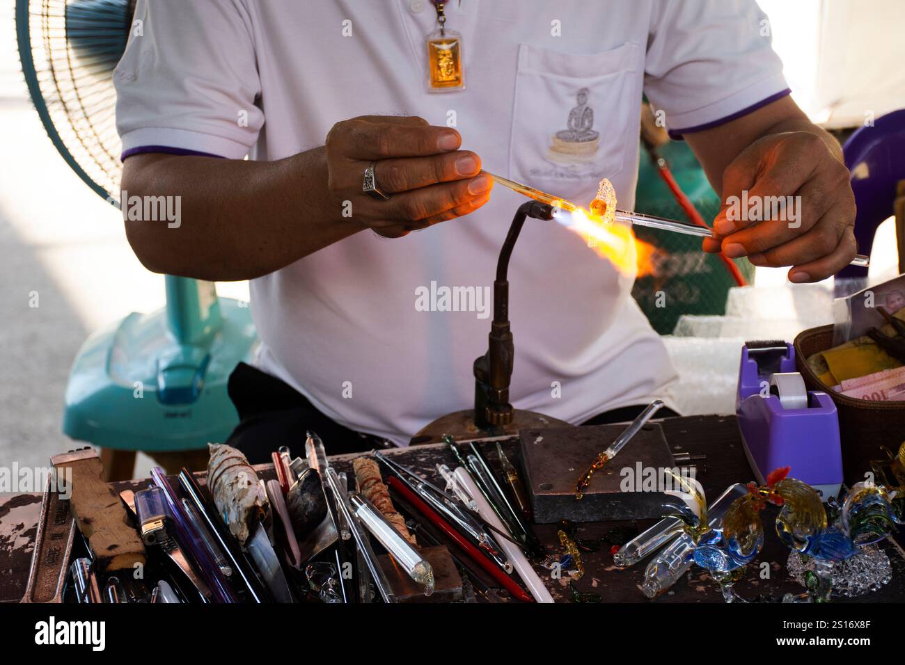 Thai craftsmanship glassmith and artist working making blown glass and ...
