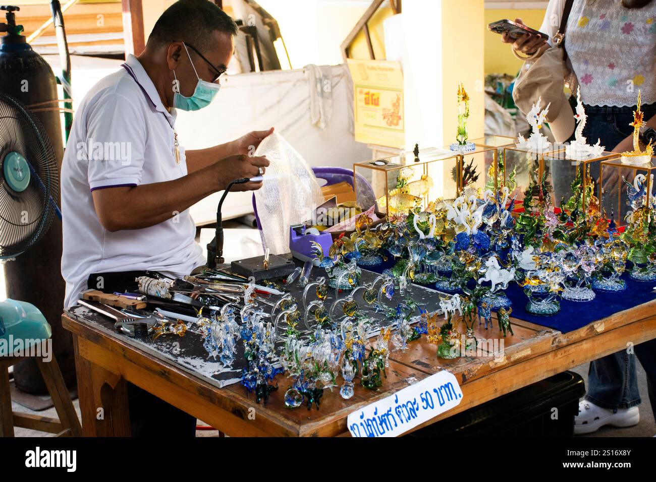 Thai craftsmanship glassmith artist working making blown glass and ...