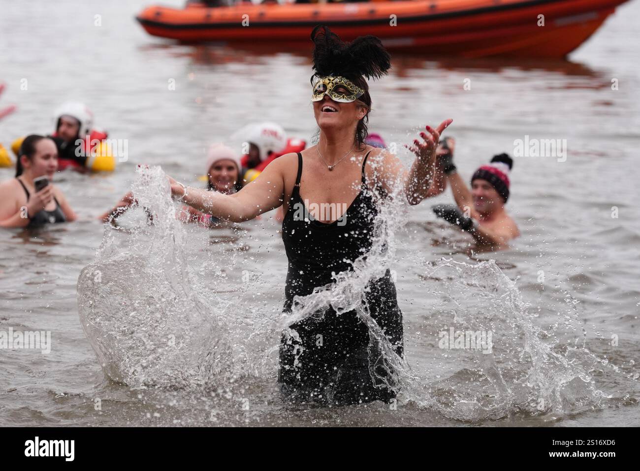 People take part in the Loony Dook New Year's Day dip in the Firth of ...