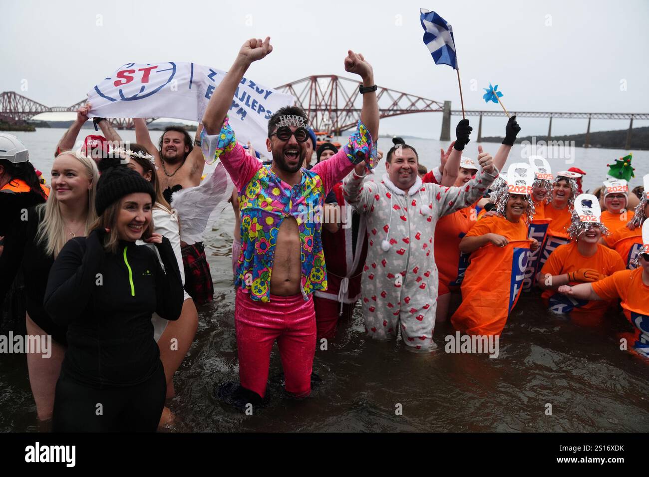 People take part in the Loony Dook New Year's Day dip in the Firth of ...