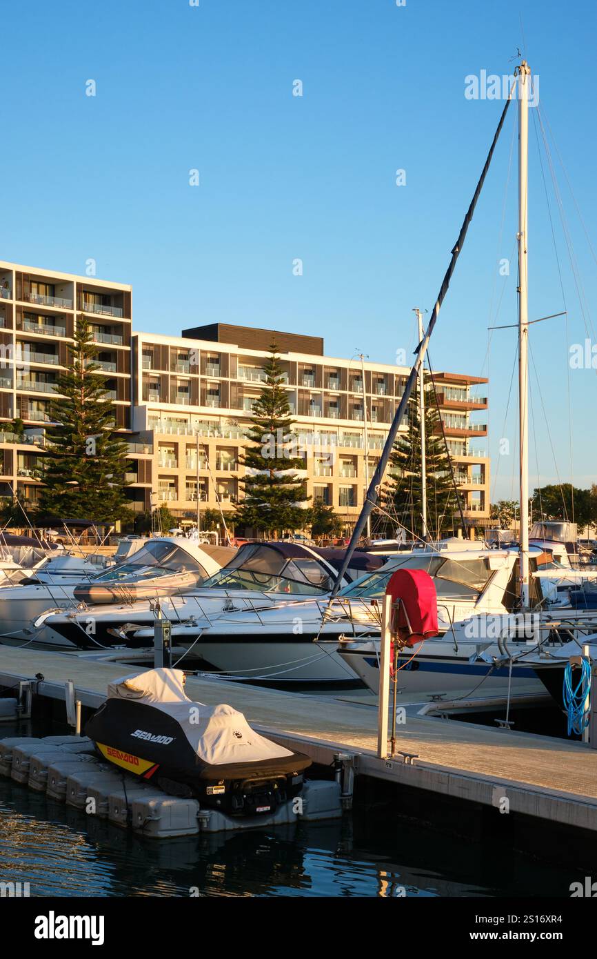 Boats, yachts and a jet ski in Port Coogee Marina in front of a modern ...