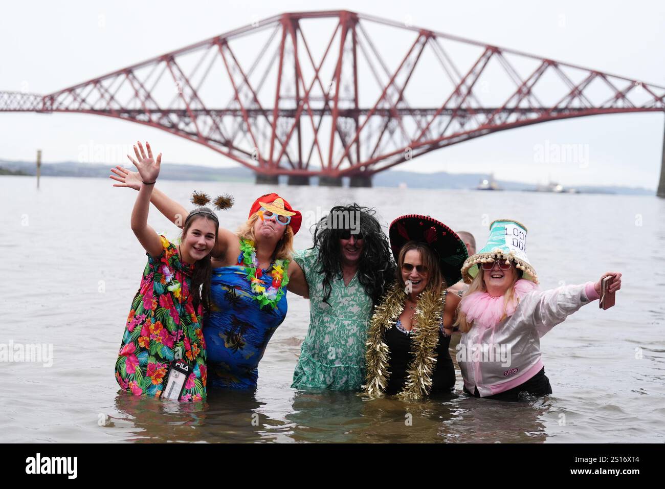 People take part in the Loony Dook New Year's Day dip in the Firth of ...