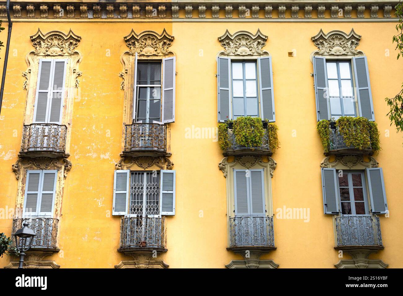 Facade of old yellow building with shuttered windows Stock Photo - Alamy