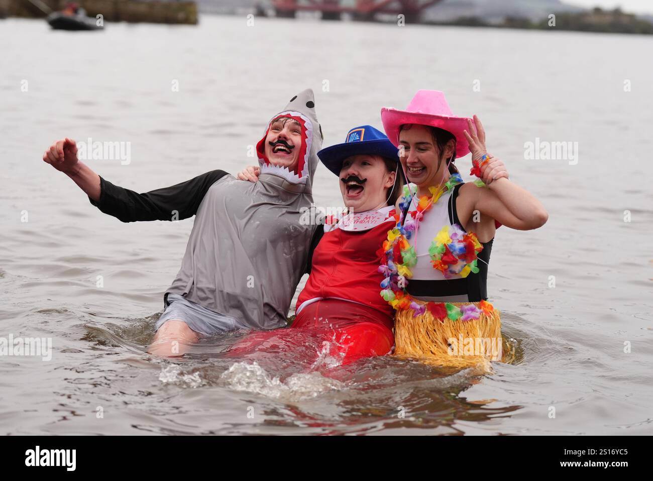 People take part in the Loony Dook New Year's Day dip in the Firth of ...