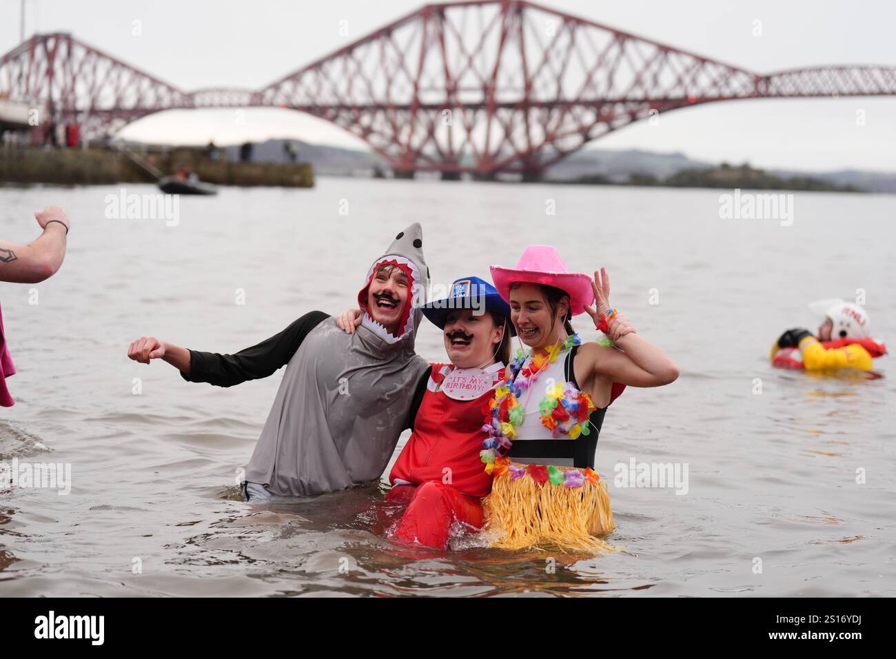 People take part in the Loony Dook New Year's Day dip in the Firth of ...