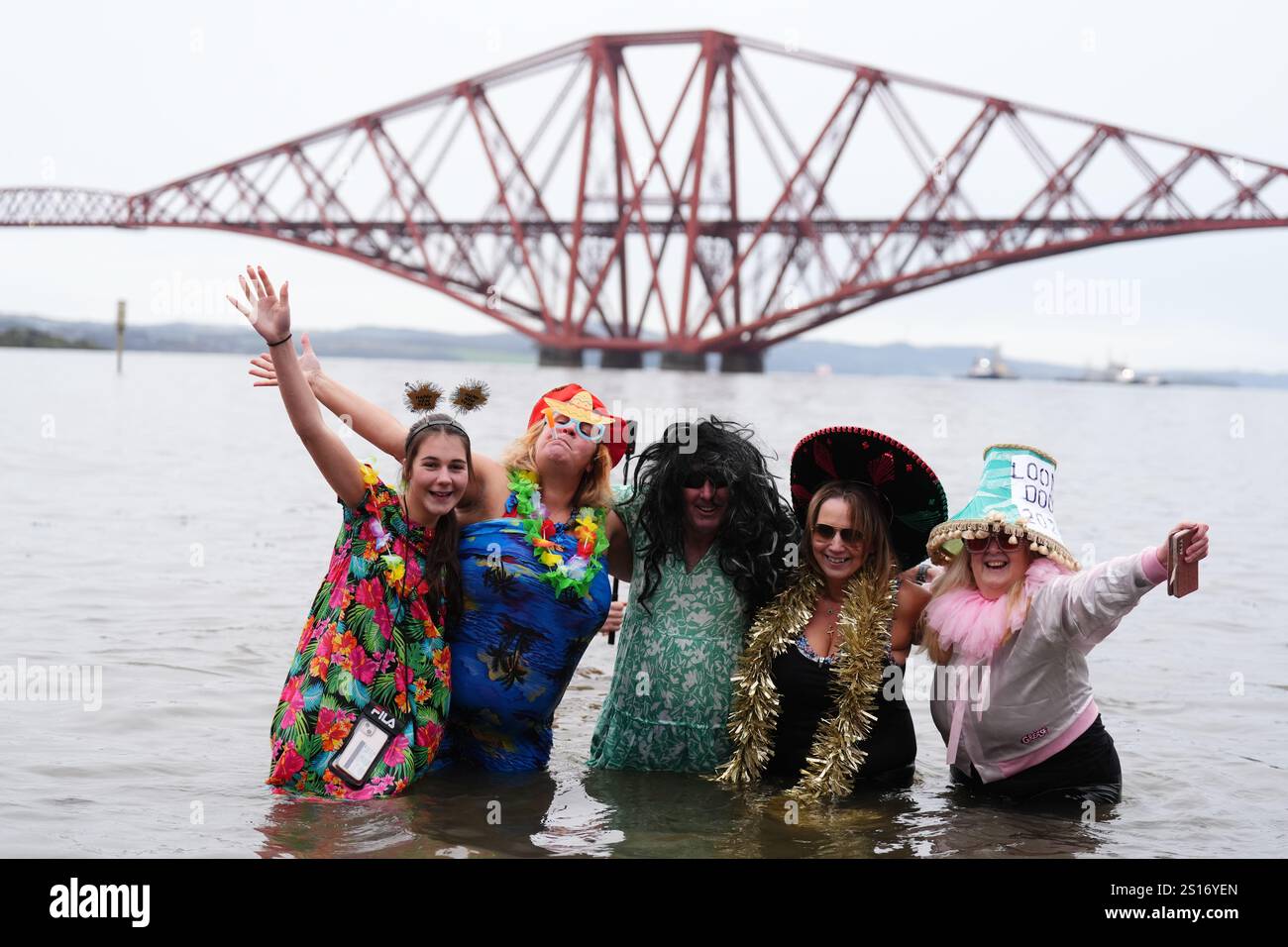 People take part in the Loony Dook New Year's Day dip in the Firth of ...