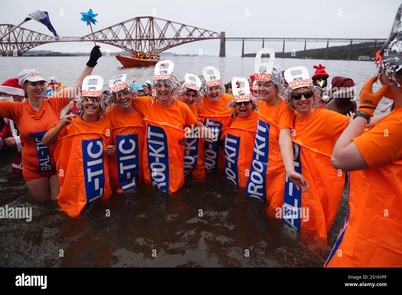 People take part in the Loony Dook New Year's Day dip in the Firth of ...